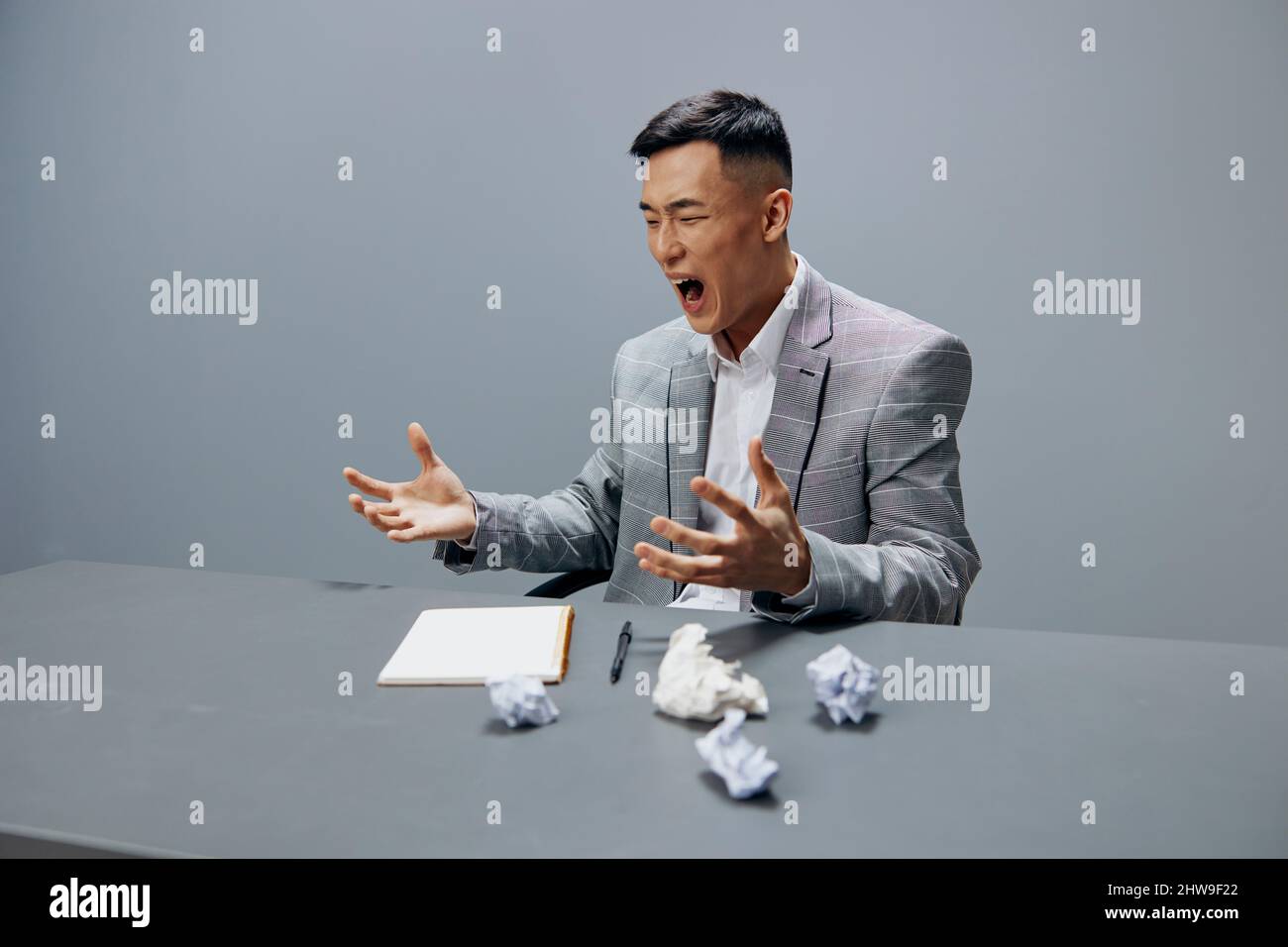 worker in a gray suit crumpled paper office official emotions isolated ...