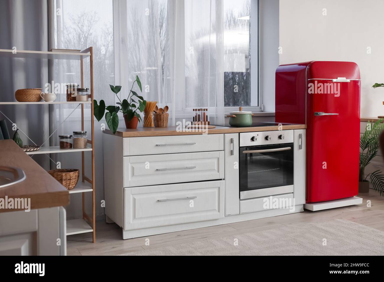 Interior of modern kitchen with red fridge and oven Stock Photo - Alamy