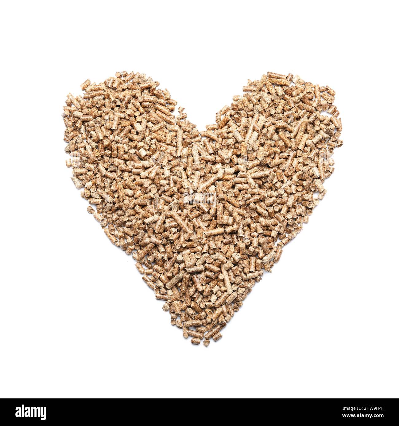 Heart made of wood pellets on white background Stock Photo - Alamy