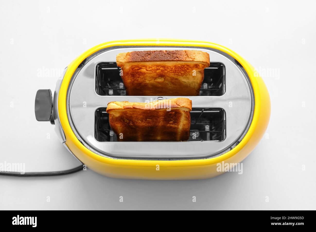 Modern toaster with bread slices on white background Stock Photo - Alamy