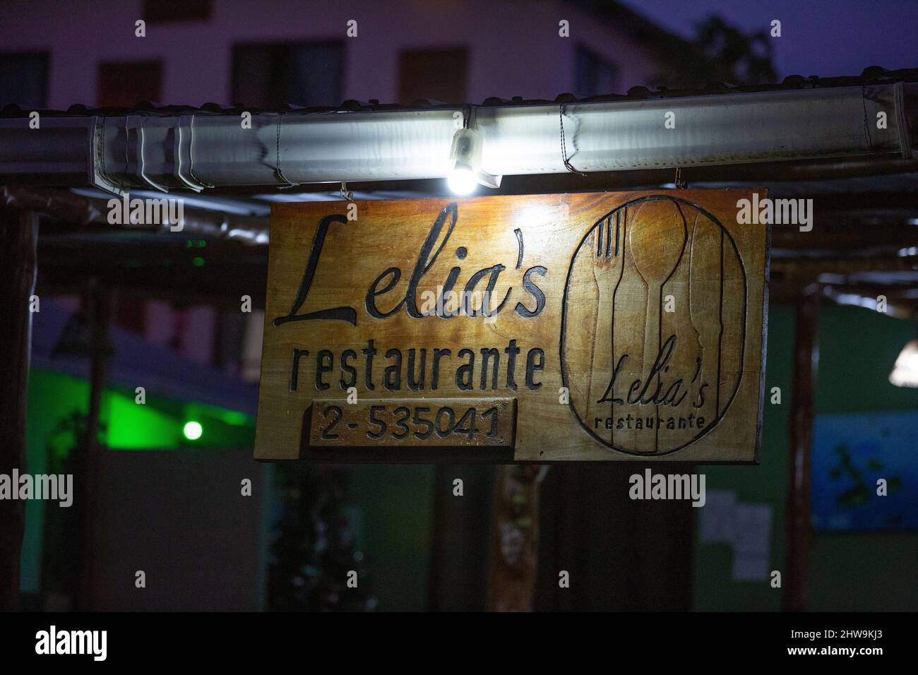 Sign outside Lelia's Restaurante at night on Floreana Island, Galapagos ...