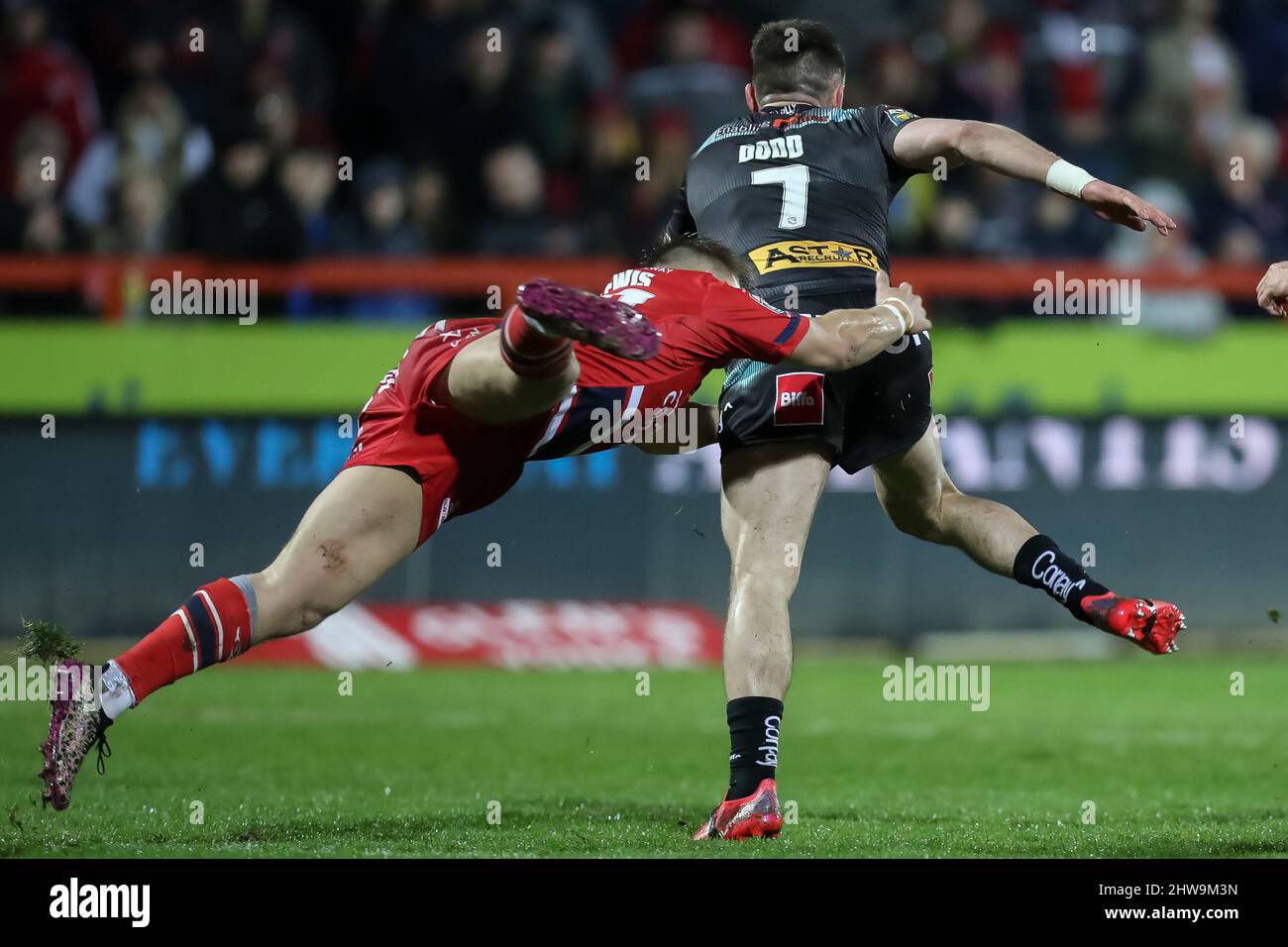 Mikey Lewis #20 of Hull KR with a flying tackle on Lewis Dodd #7 of St ...