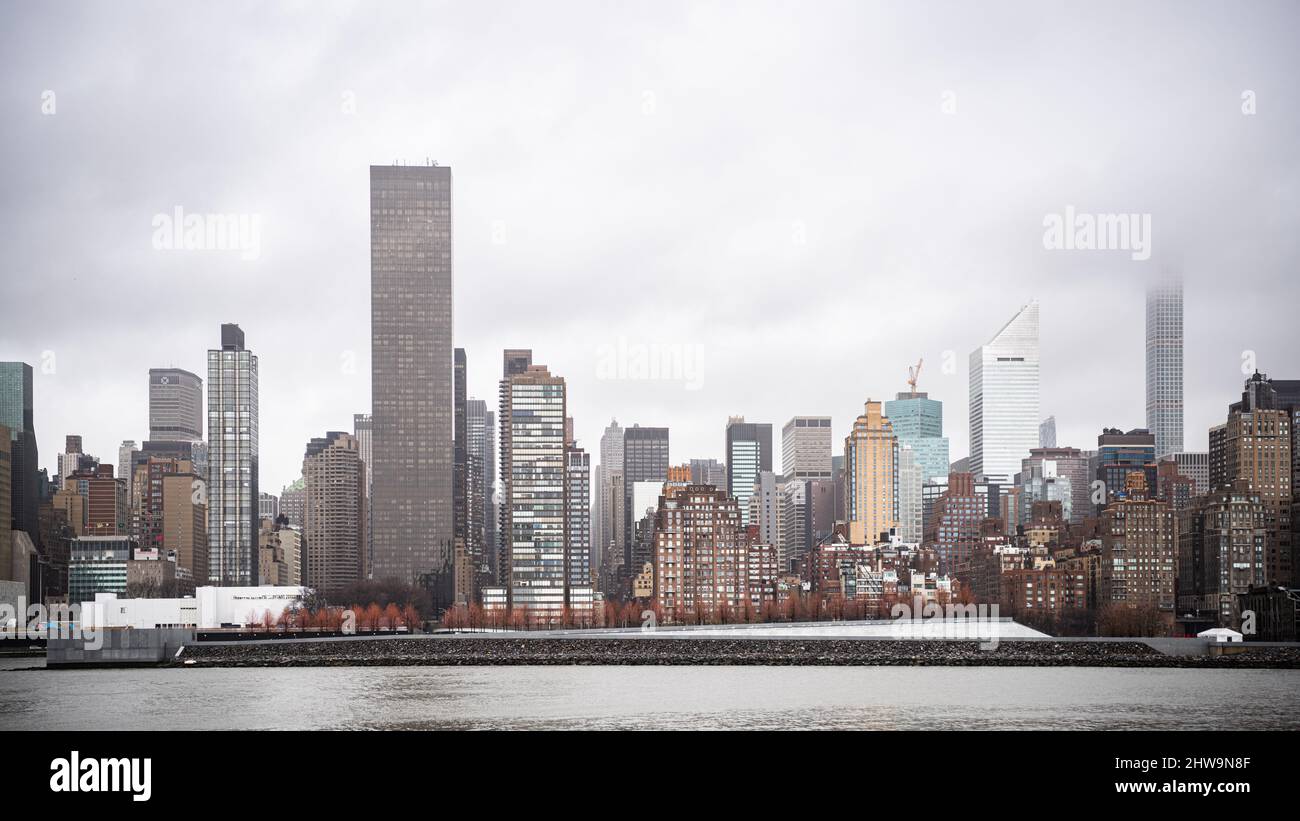 Beautiful view of tall buildings by the sea in Manhattan, New York City ...