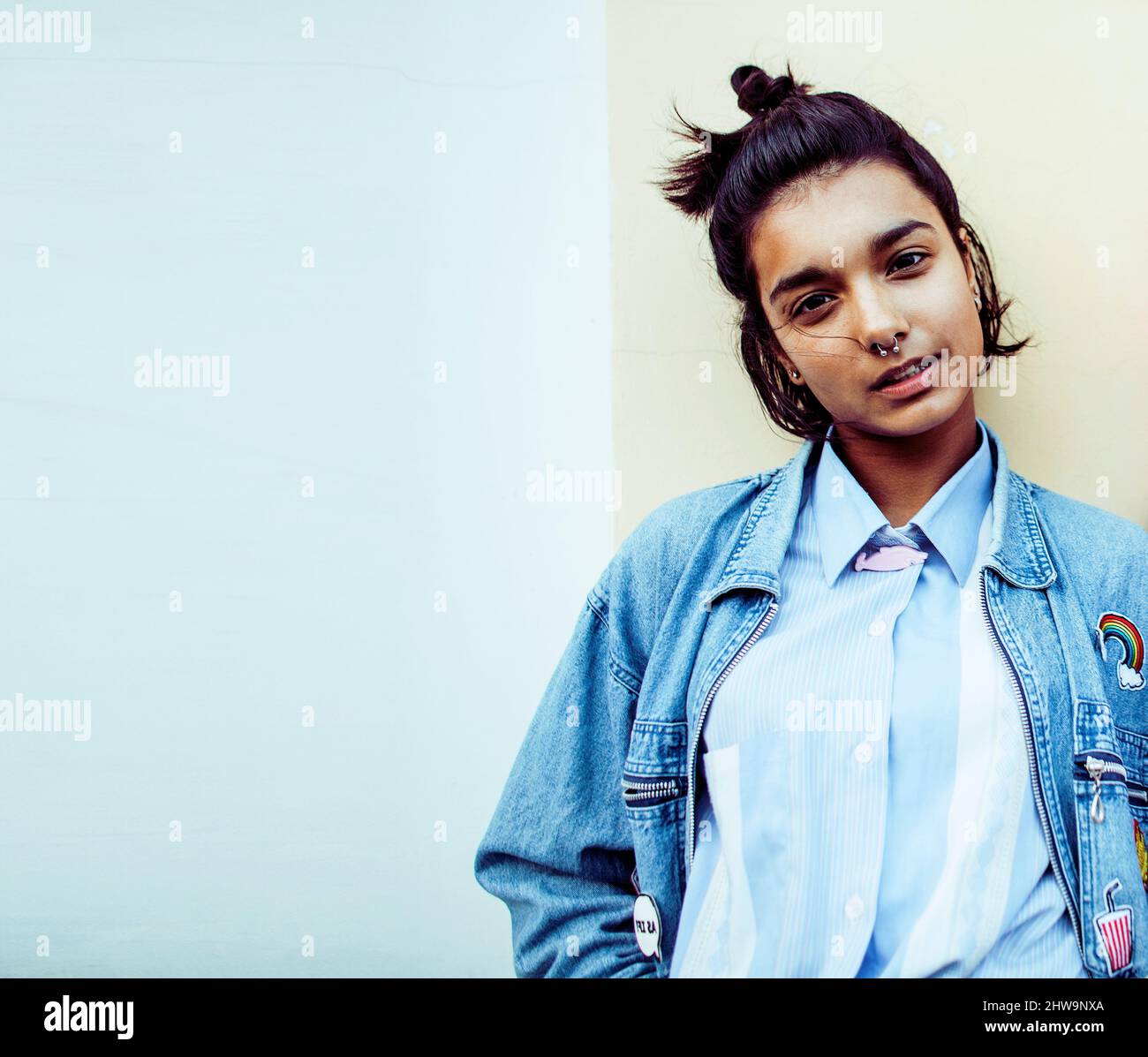Two teenage girls infront of university building smiling, having fun ...