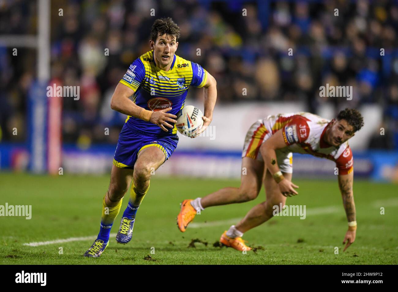 Stefan Ratchford #1 of Warrington Wolves evades the tackle attempt from ...