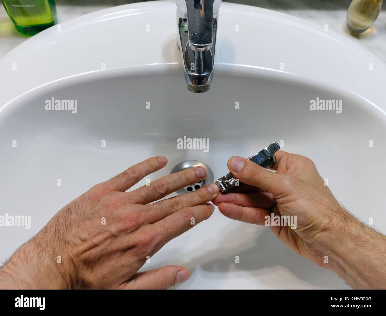 Top view of a man cutting his nails on a bathroom sink Stock Photo - Alamy
