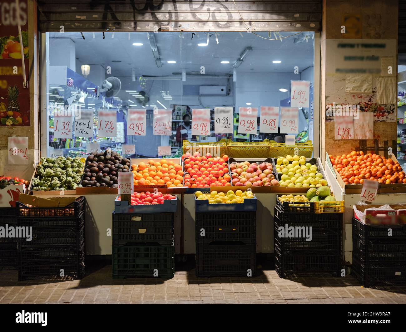 Fruit shop with boxes full of fruit outside at night Stock Photo - Alamy