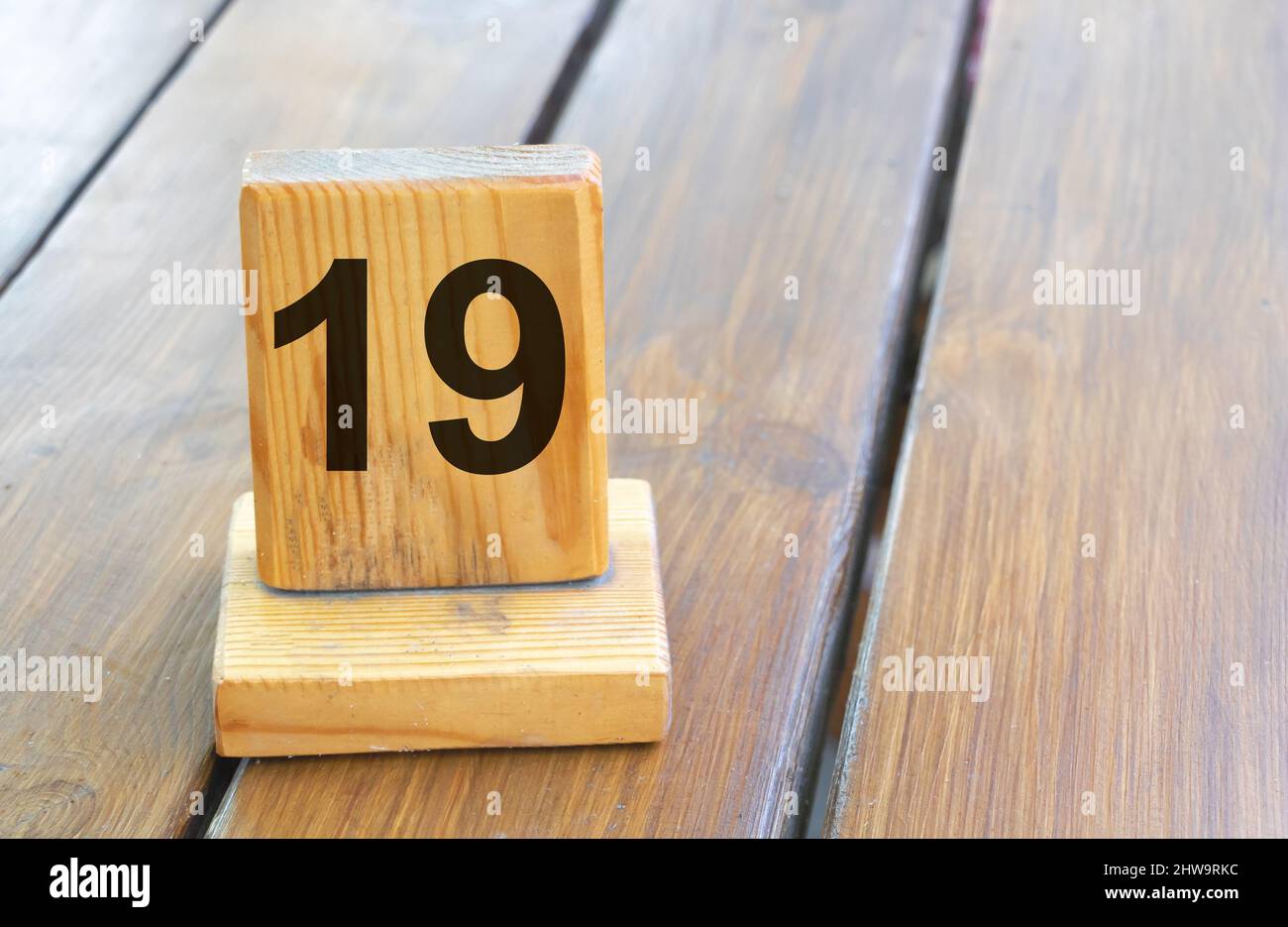 Wooden priority number 19 on a plank tab Stock Photo - Alamy