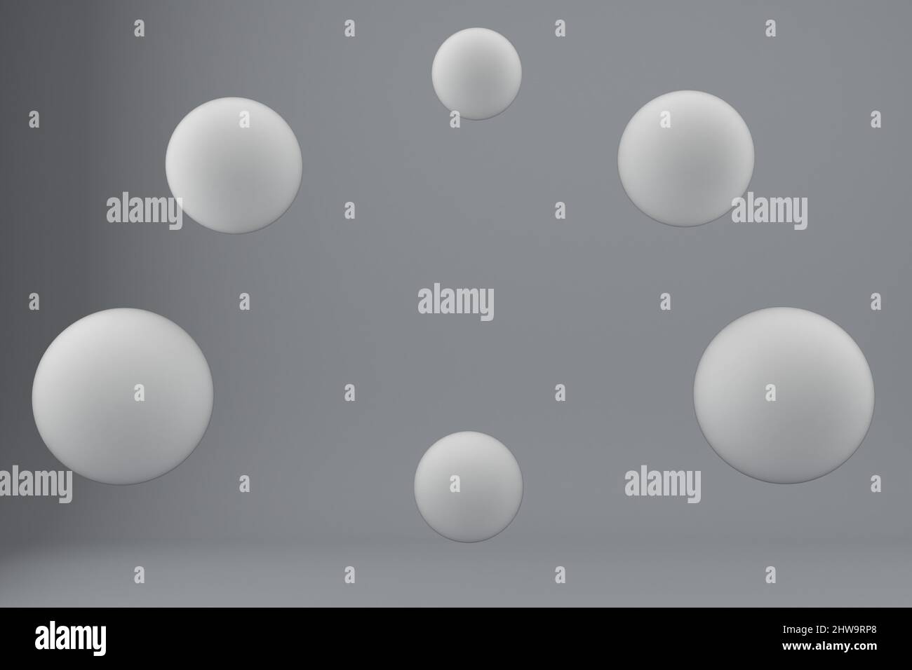 3D rendering of white spheres floating against a gray background Stock ...