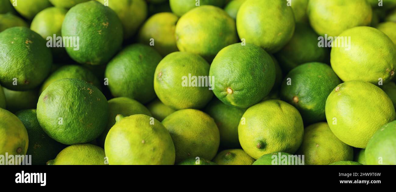 pile heap stack of lime limes at farmers market grocery fruit stand ...