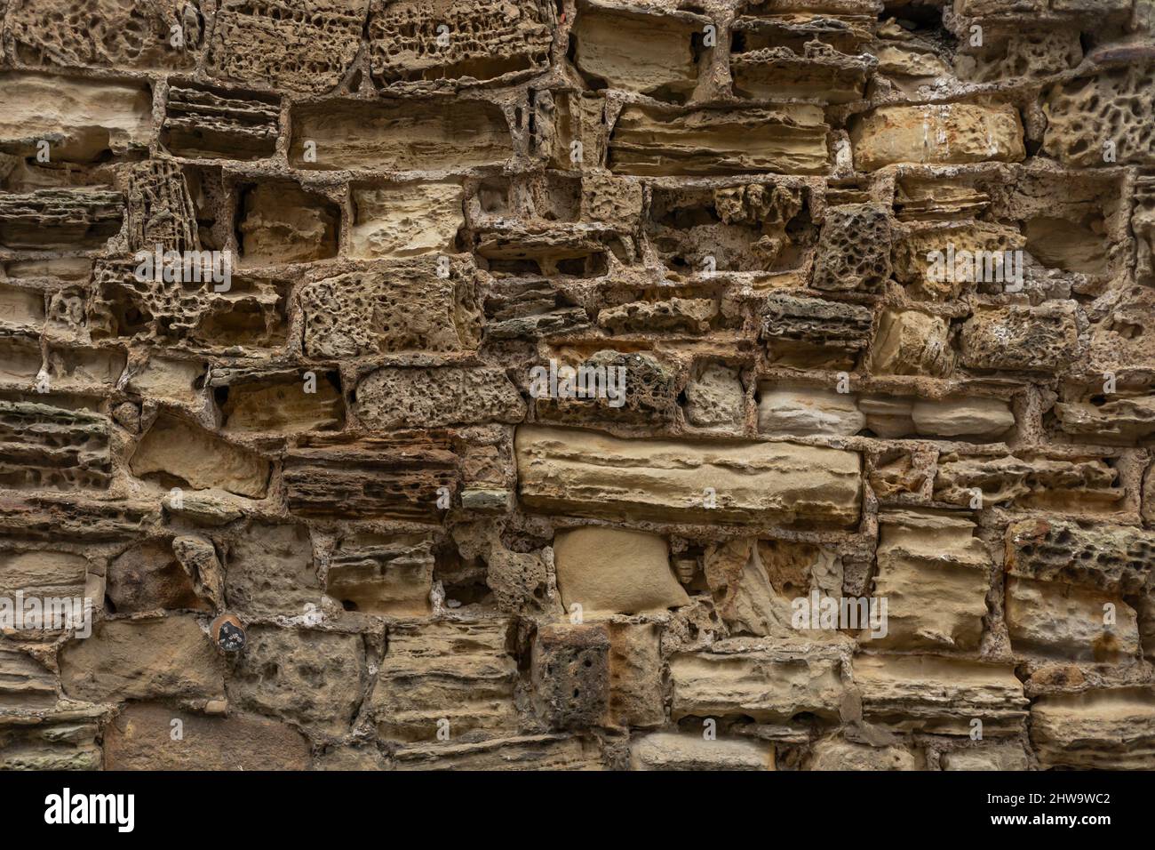 Unique background of spalled brickwork of honey coloured stone Stock ...