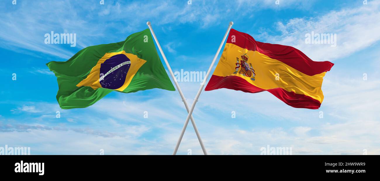 crossed national flags of Brazil and Spane flag waving in the wind at ...