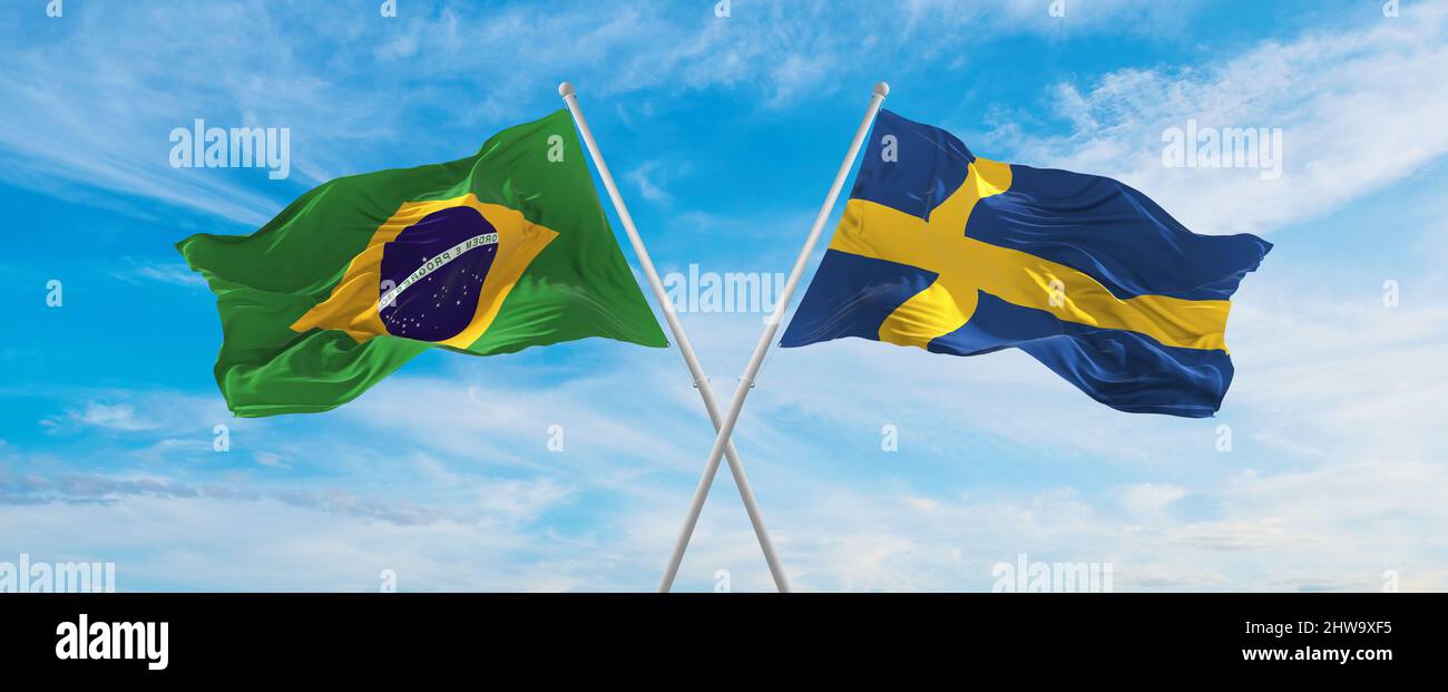 crossed national flags of Brazil and SWEDEN flag waving in the wind at ...