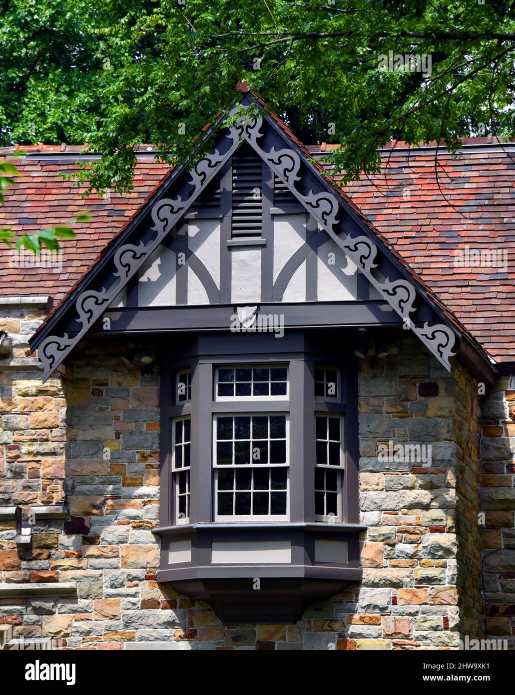 Beautiful bay window sits in second story of home. It is trimmed in ...