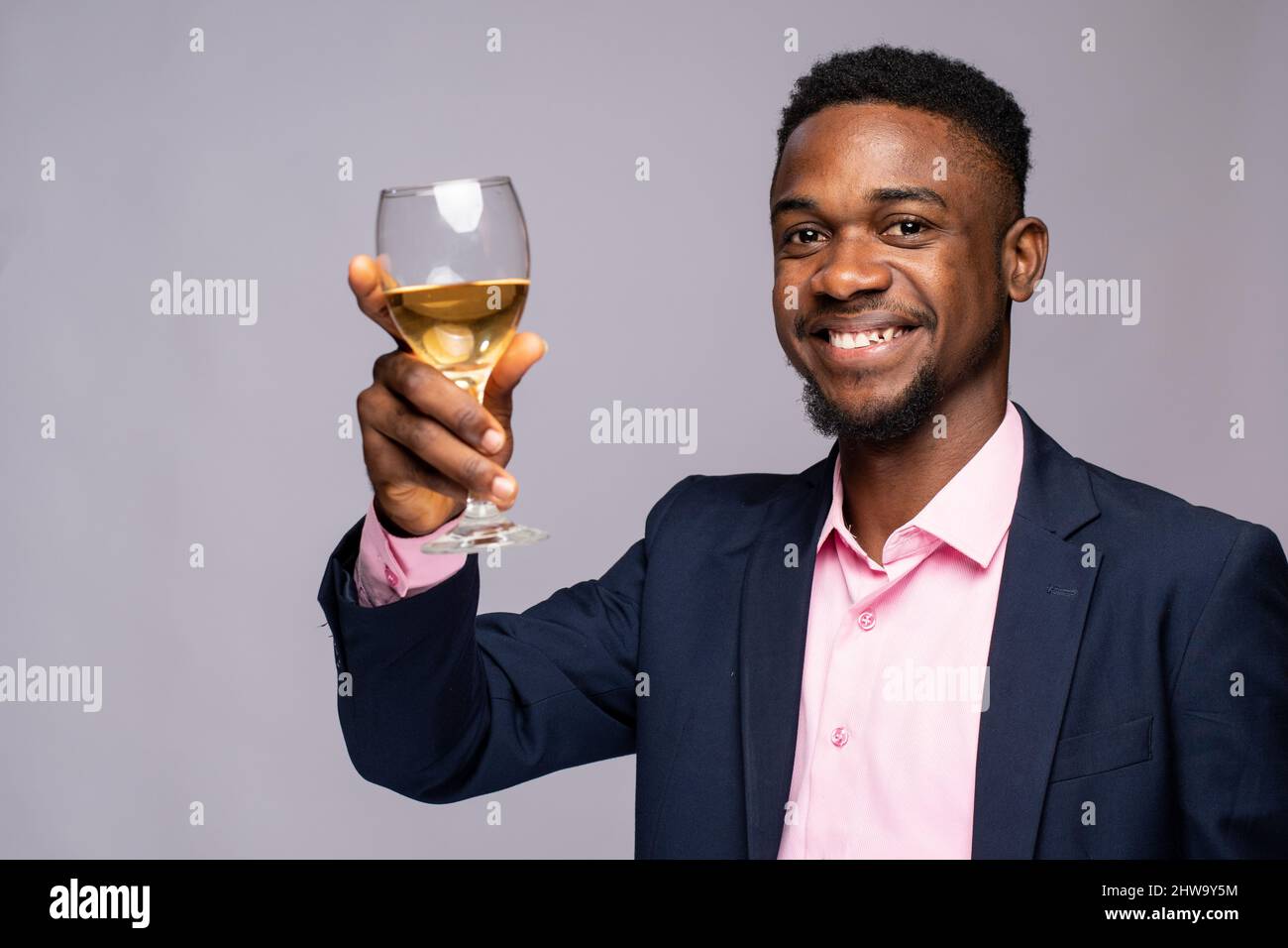 African American male giving a toast with a wine glass Stock Photo - Alamy