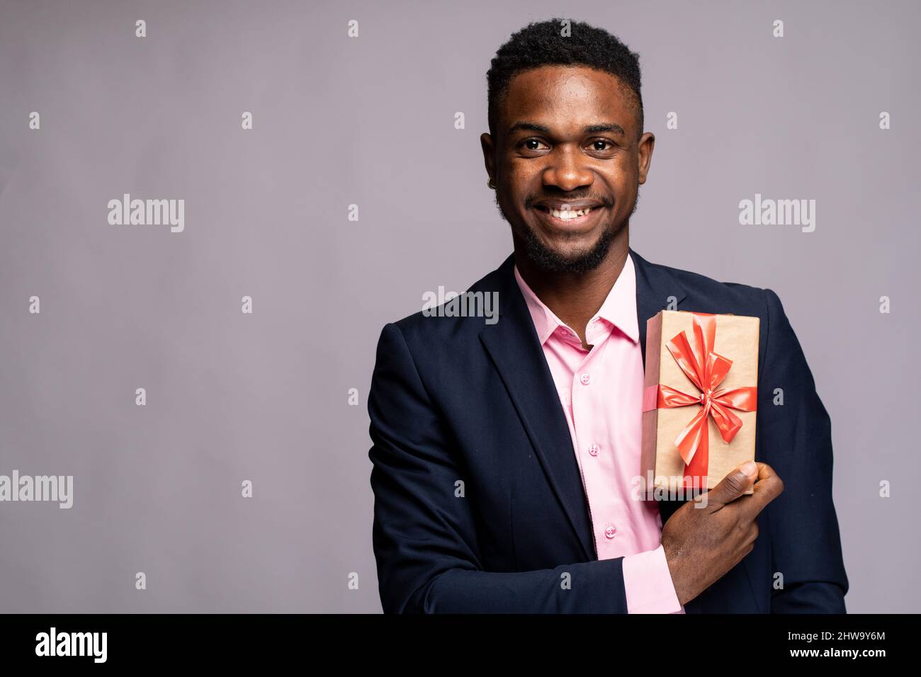 African American male holding a present Stock Photo - Alamy