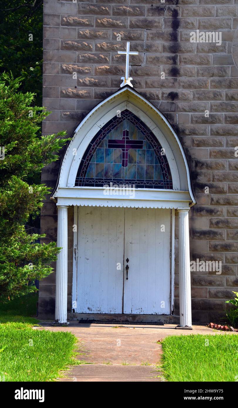 St. Luke Catholic Church has entry with white wooden cross and cross on ...