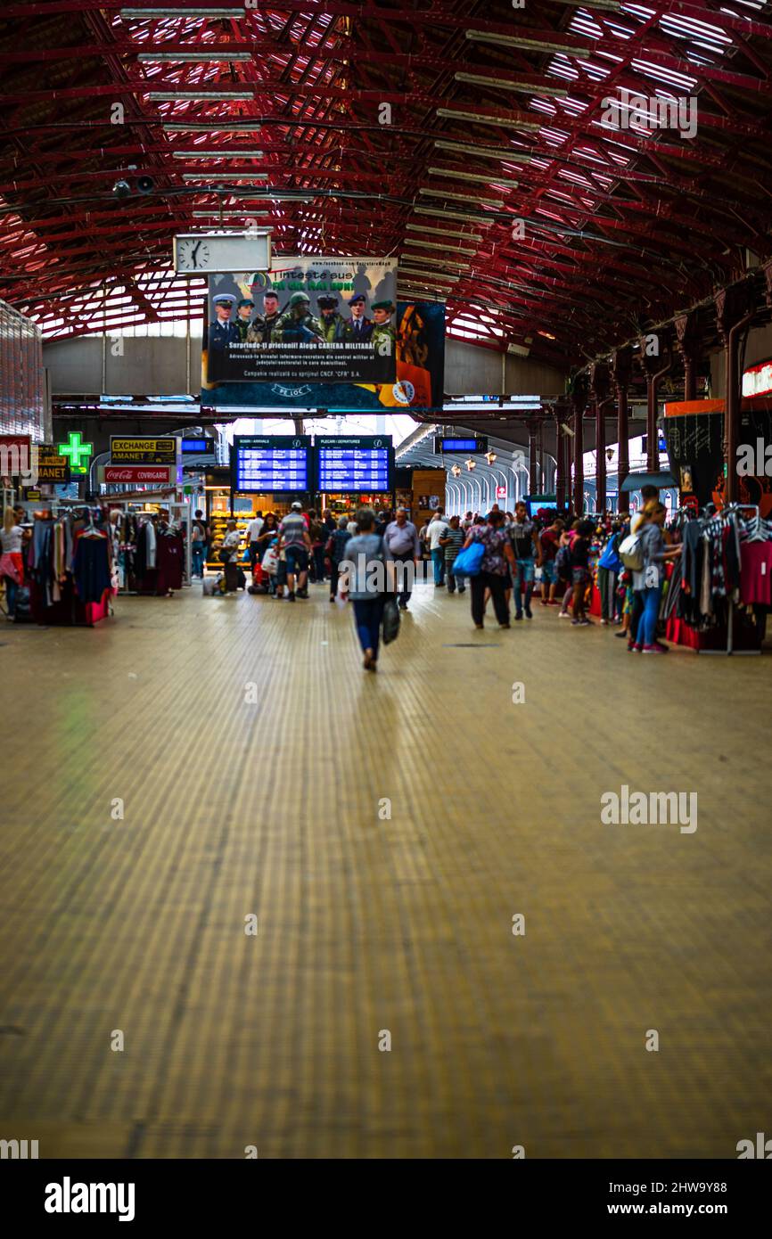 Travelers and commuters waiting for a train on the train platform of ...