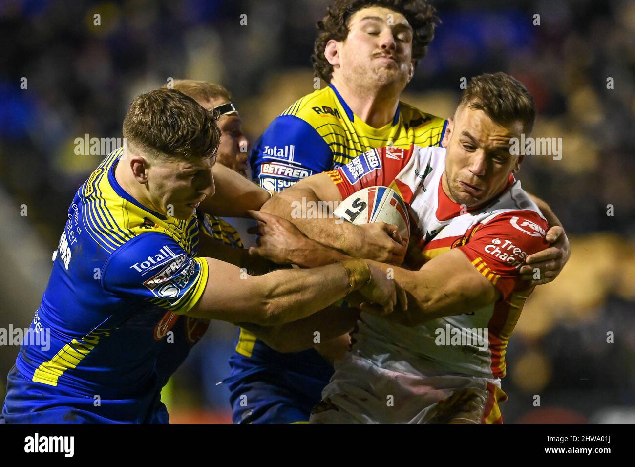 Mickael Goudemand (17) of Catalans Dragons is tackled by Rob Mulhern ...