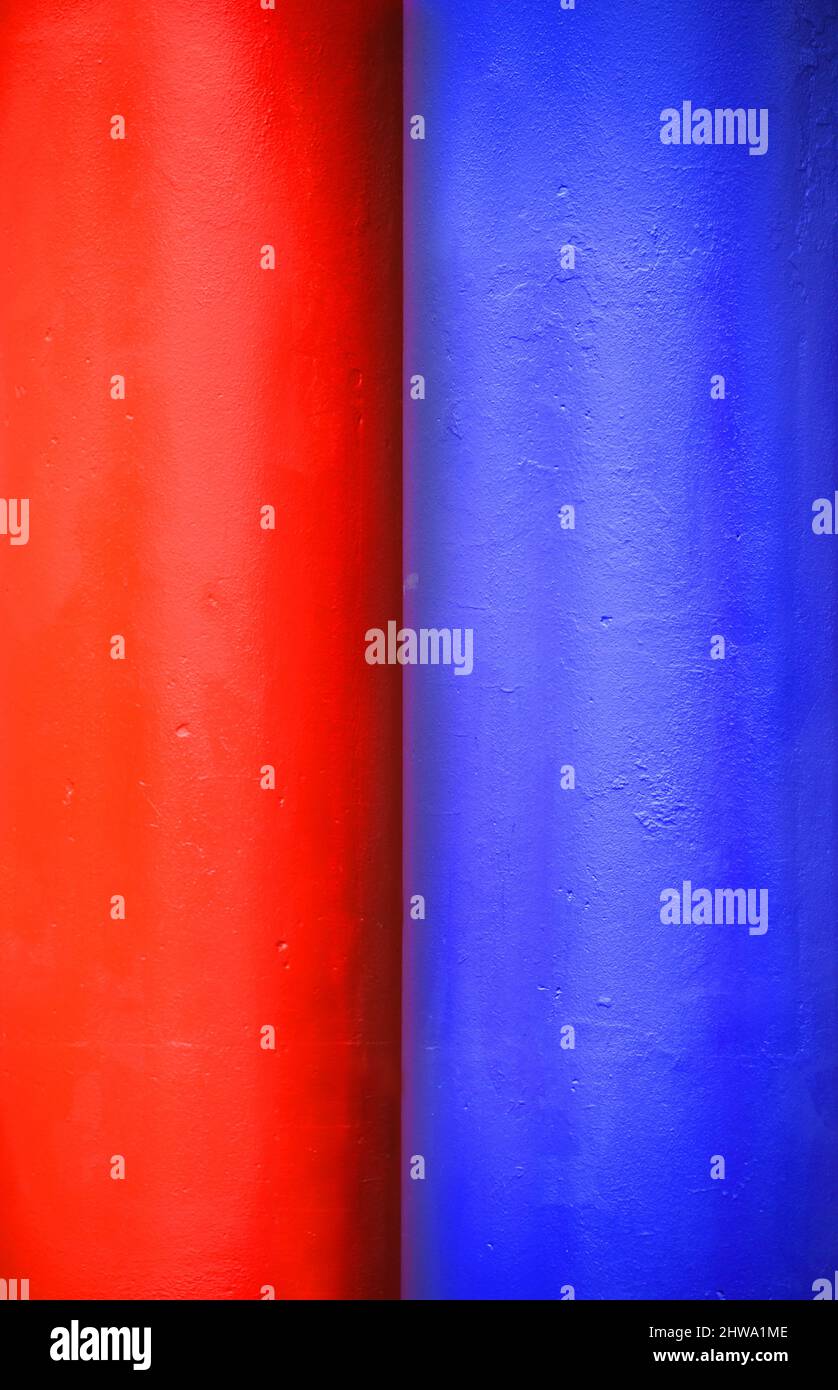 Two pillars, painted red and purple, front preschool. Pillars are ...