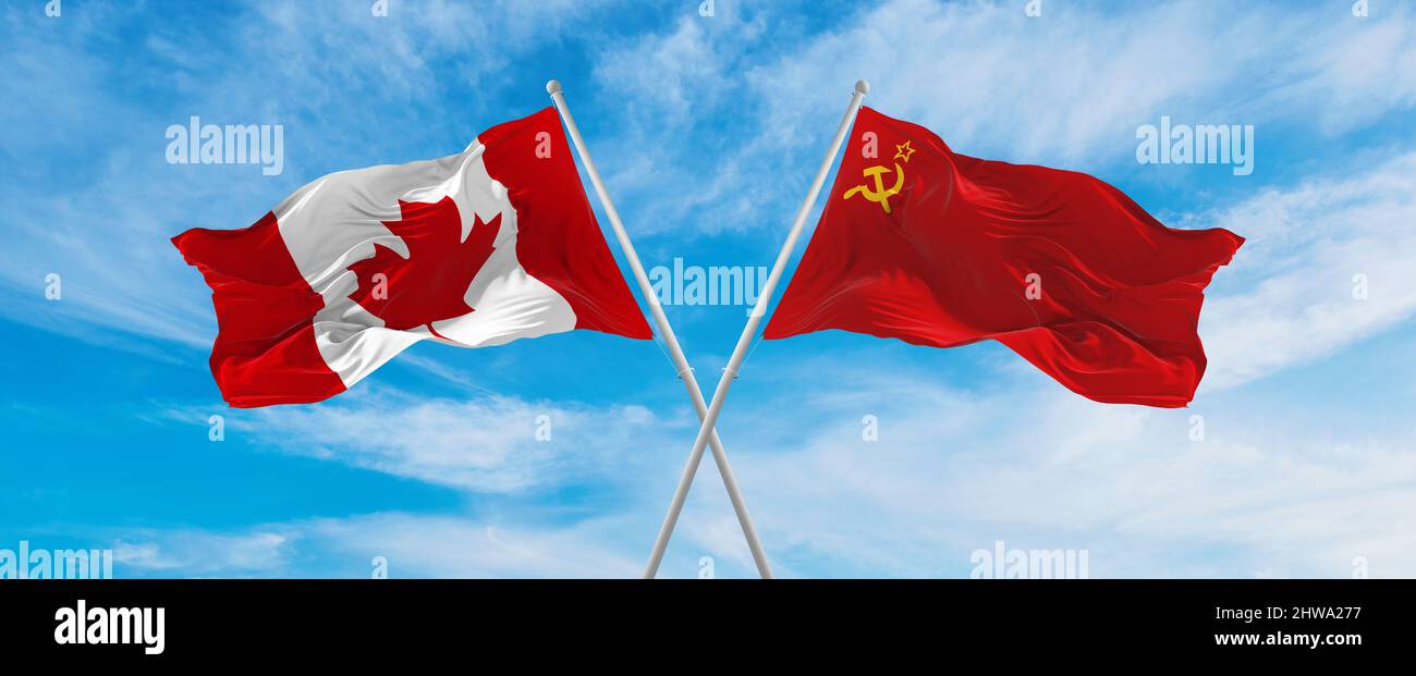 crossed national flags of Canada and ussr flag waving in the wind at ...