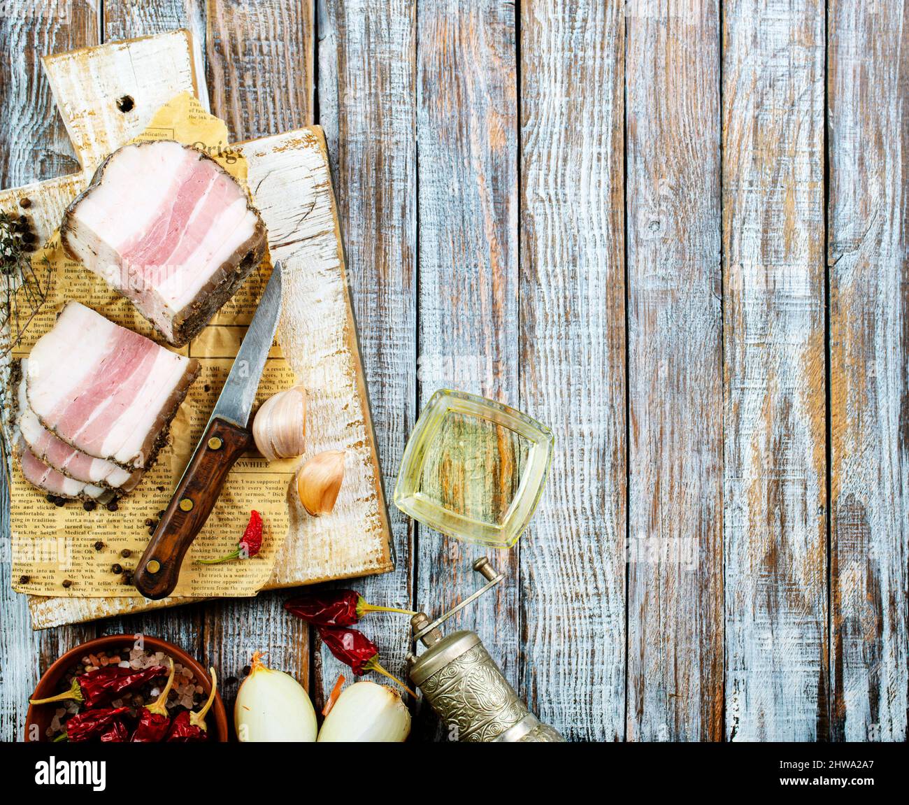 Chunks of salted bacon on dark background. Healthy food with pranami ...
