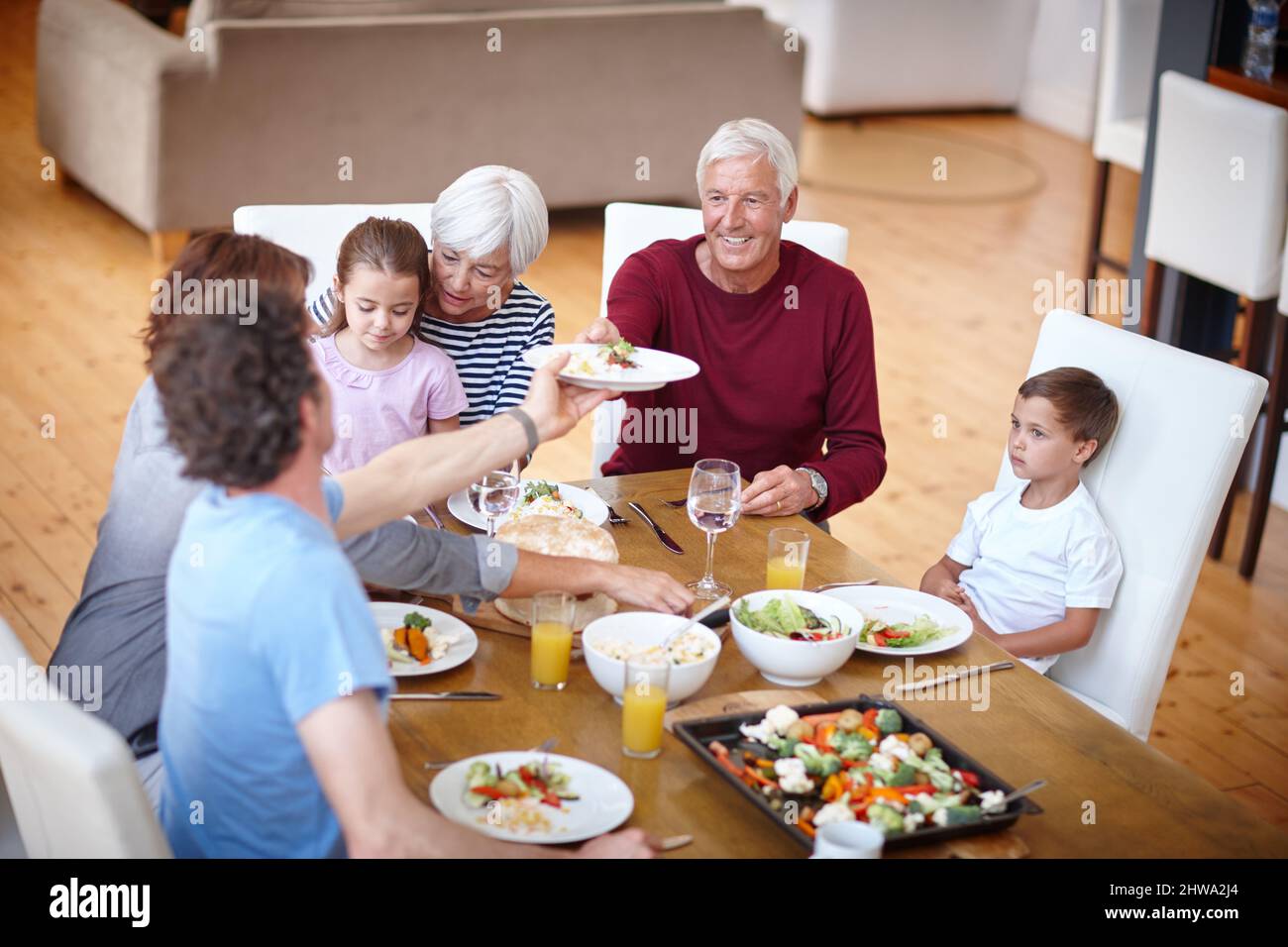Dig in. Shot of a multi generational family having a meal together ...