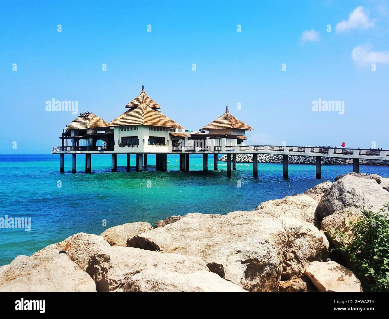 Scenic view of overwater bungalows over the tranquil turquoise water ...