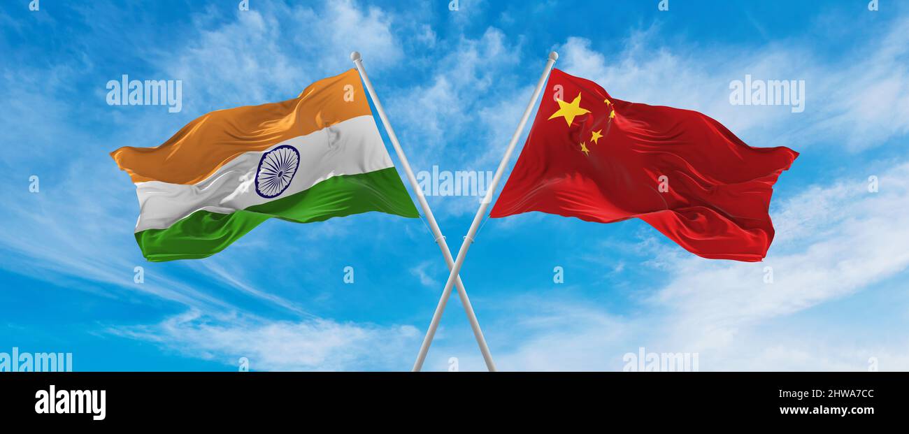 crossed national flags of India and china flag waving in the wind at ...