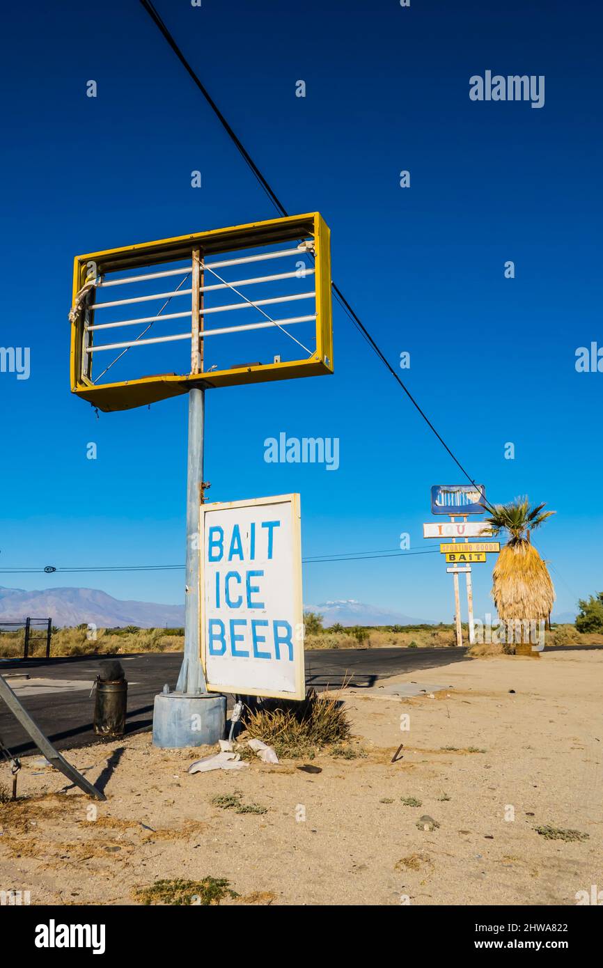 Two dilapidated roadside tall business signs with their main signage ...