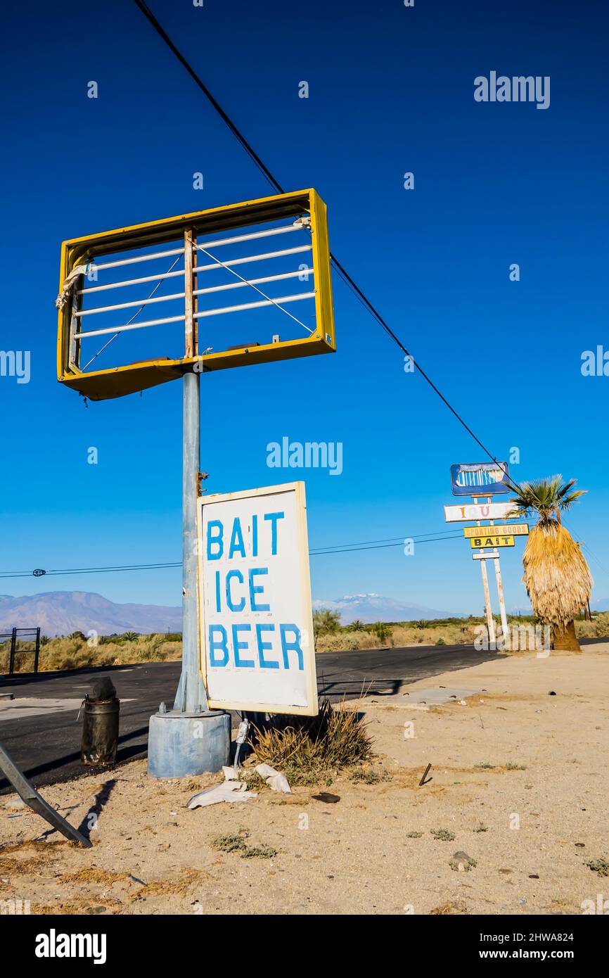 Two dilapidated roadside tall business signs with their main signage ...