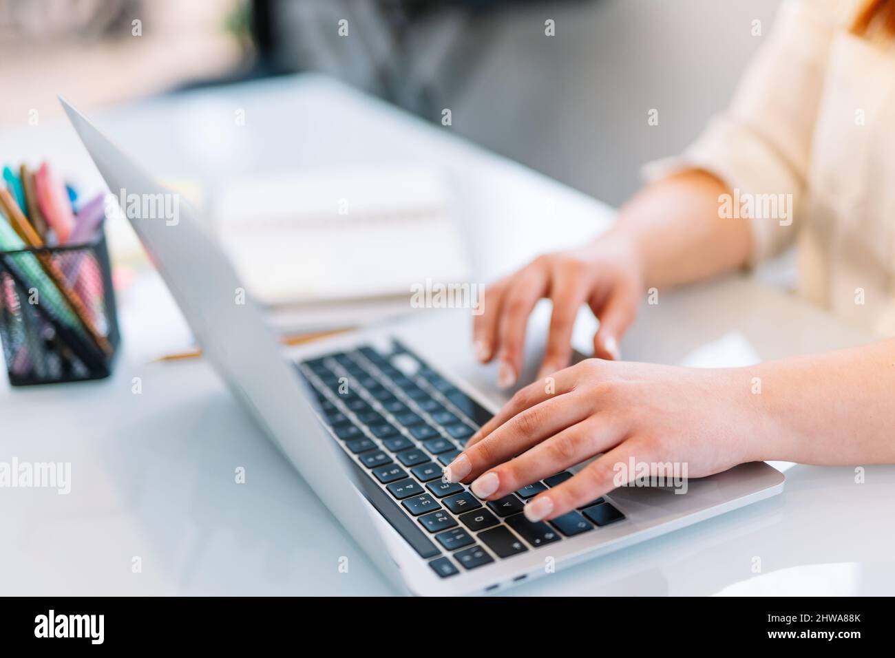 Young girl typing on laptop at home Stock Photo - Alamy