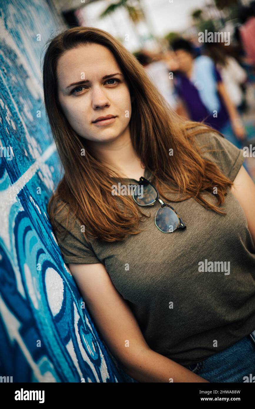 Street style photo shoot with a young pretty woman in the colorful ...