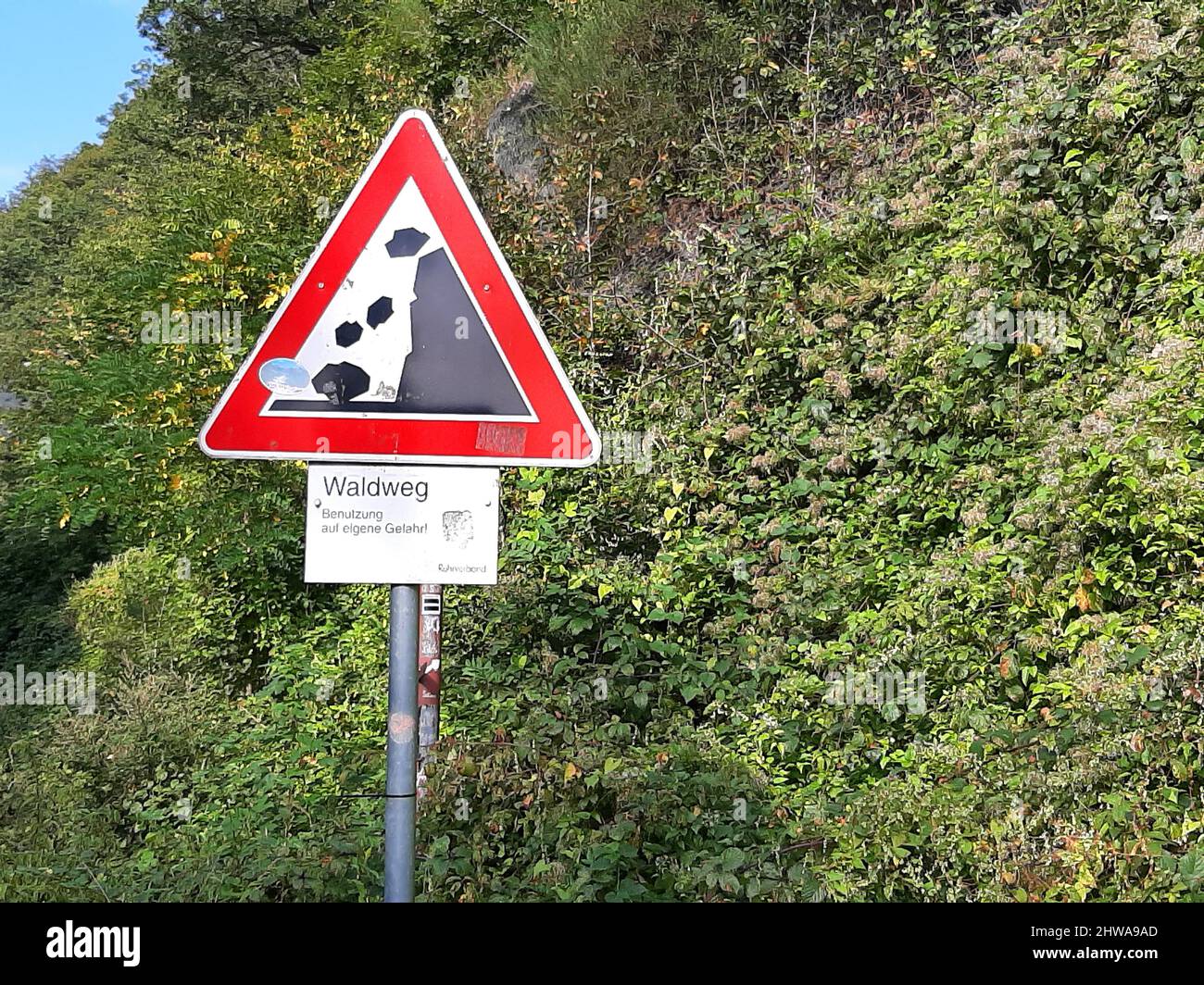 warning sign falling or fallen rocks at a forest path, Germany Stock ...