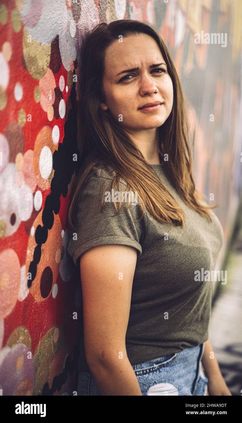 Street style photo shoot with a young pretty woman in the colorful ...