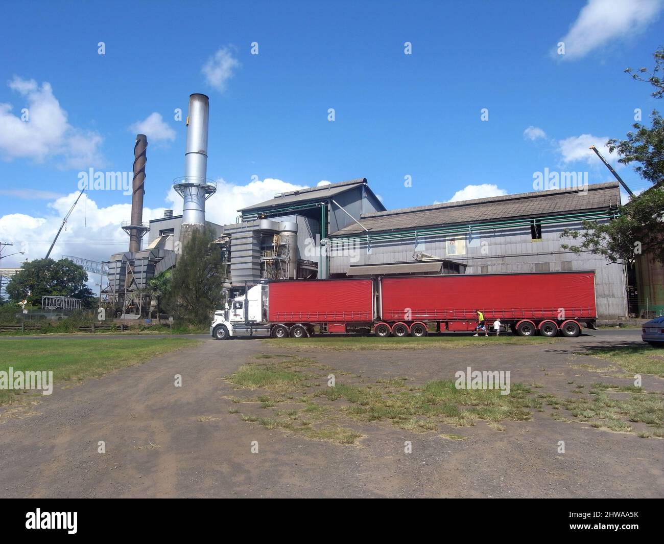 red roadtrain in front of sugar refinery , Australia, Queensland Stock ...