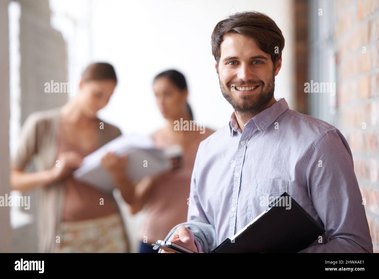 Three young people one holding hi-res stock photography and images - Alamy