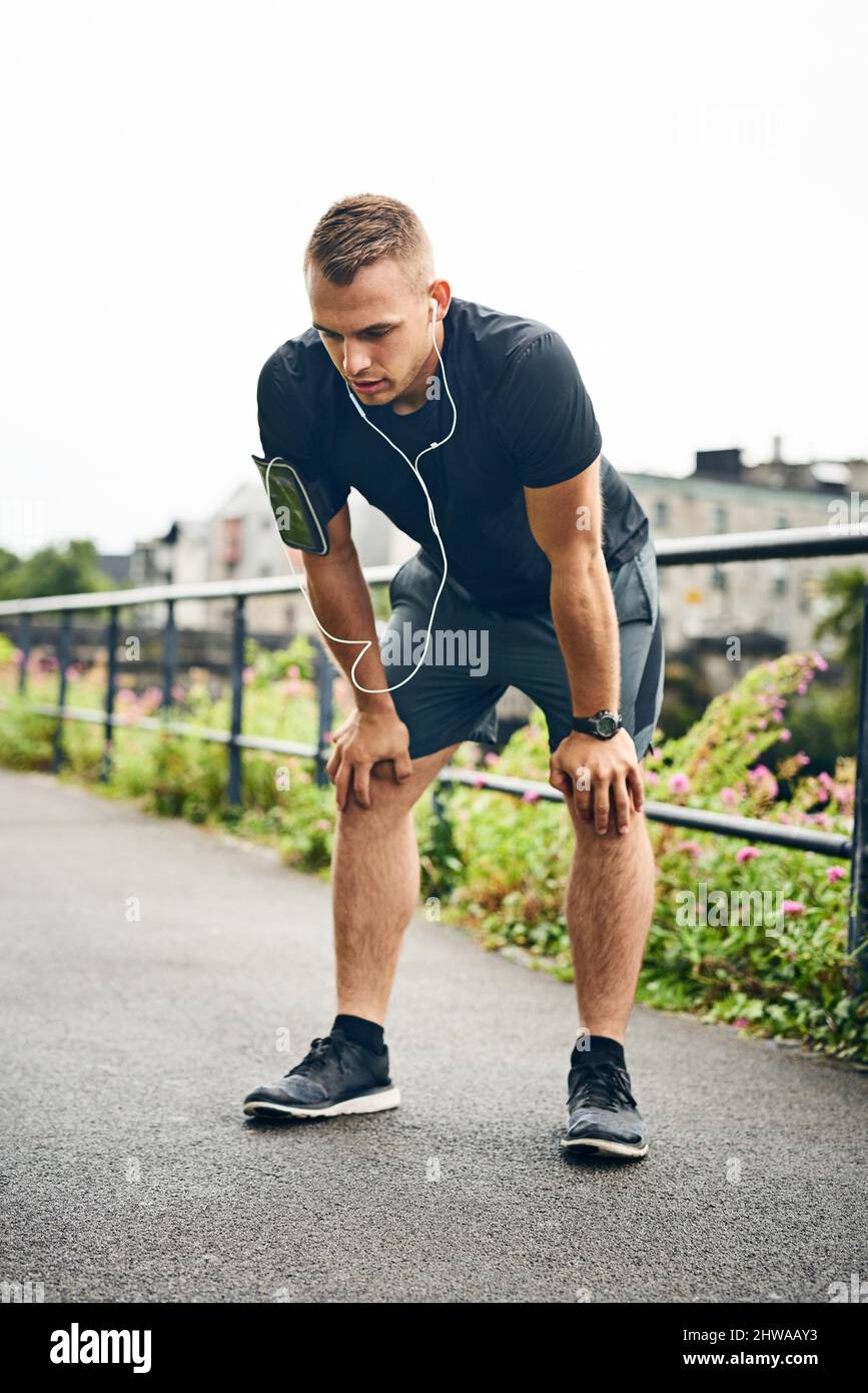 Push your limits to reach your strengths. Shot of a sporty young man ...