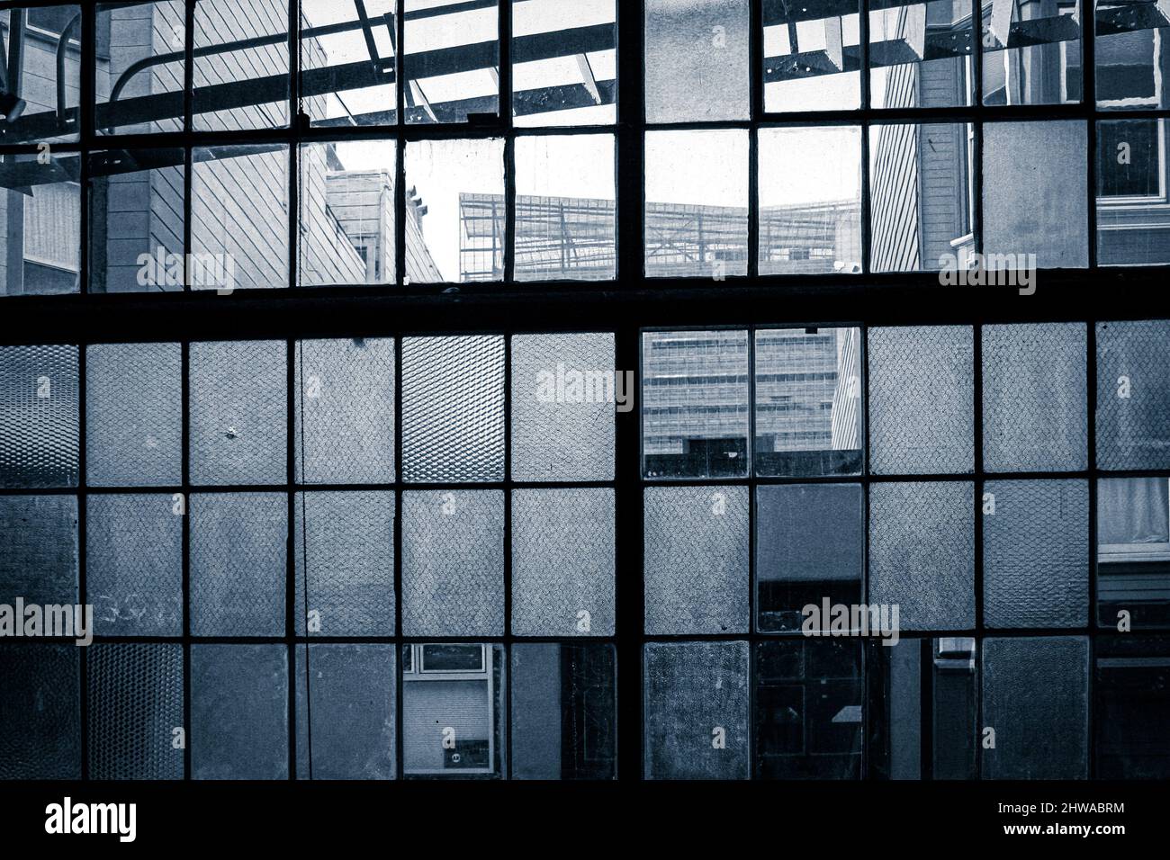 Grayscale of glass window pane against factory fire escape Stock Photo ...