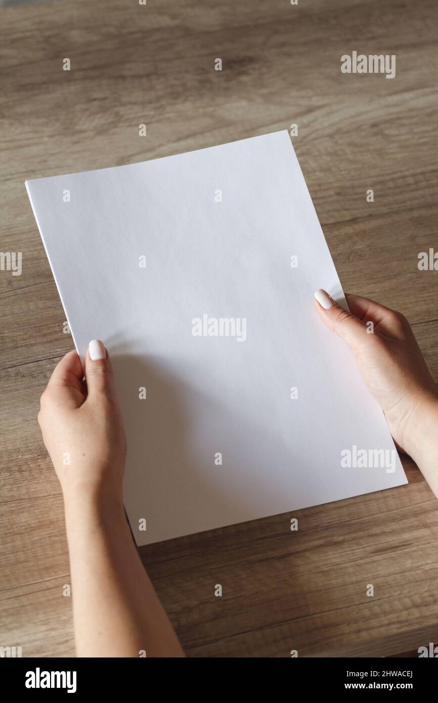 Person holding a4 paper hi-res stock photography and images - Alamy