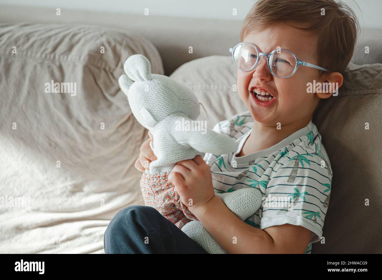 Child with autism hugs a toy, cries and gets angry Stock Photo - Alamy