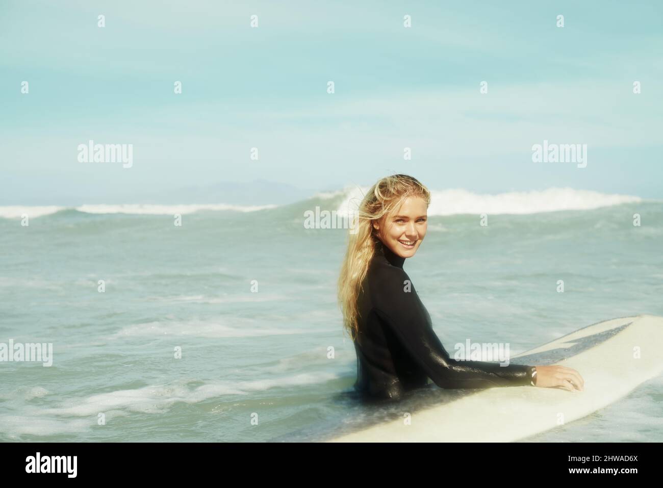 Hitting the waves. A female surfer in the ocean Stock Photo - Alamy