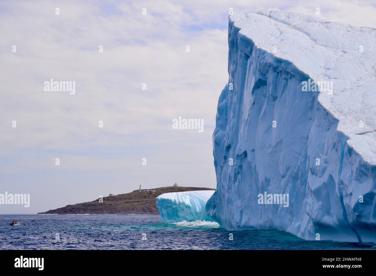 Steep sided iceberg in bay outside St. John's with Cape Spear on the ...