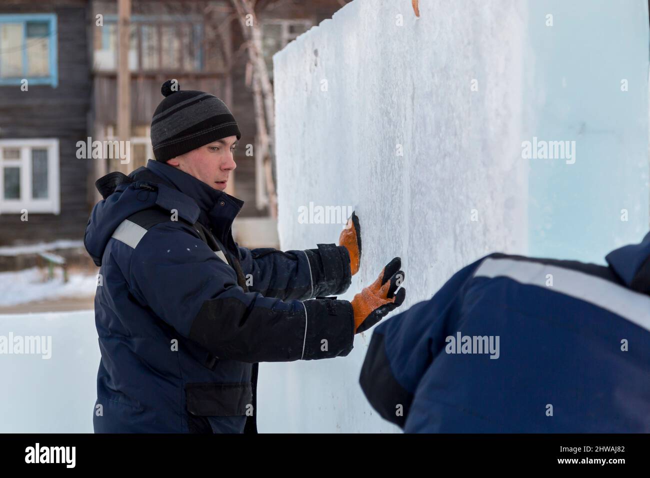 Installer in winter gear at the installation of ice panels Stock Photo ...