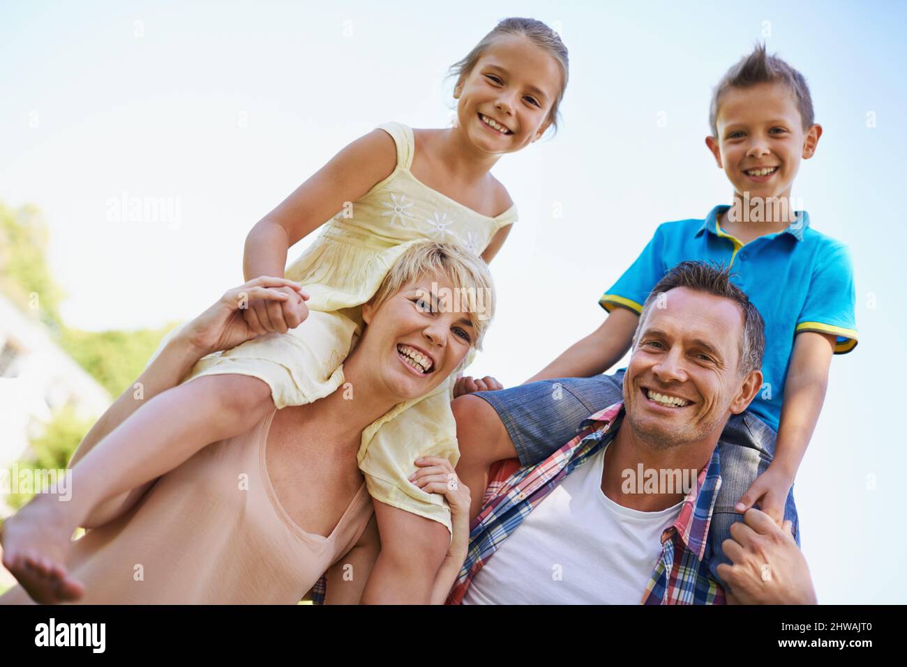 A happy loving family. A portrait of two happy parents carrying their ...