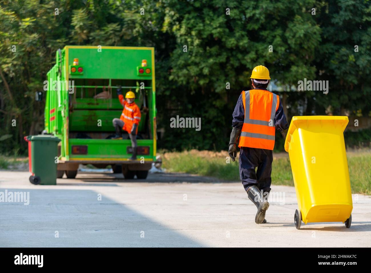 Garbage collector, Garbage man working together on emptying dustbins ...