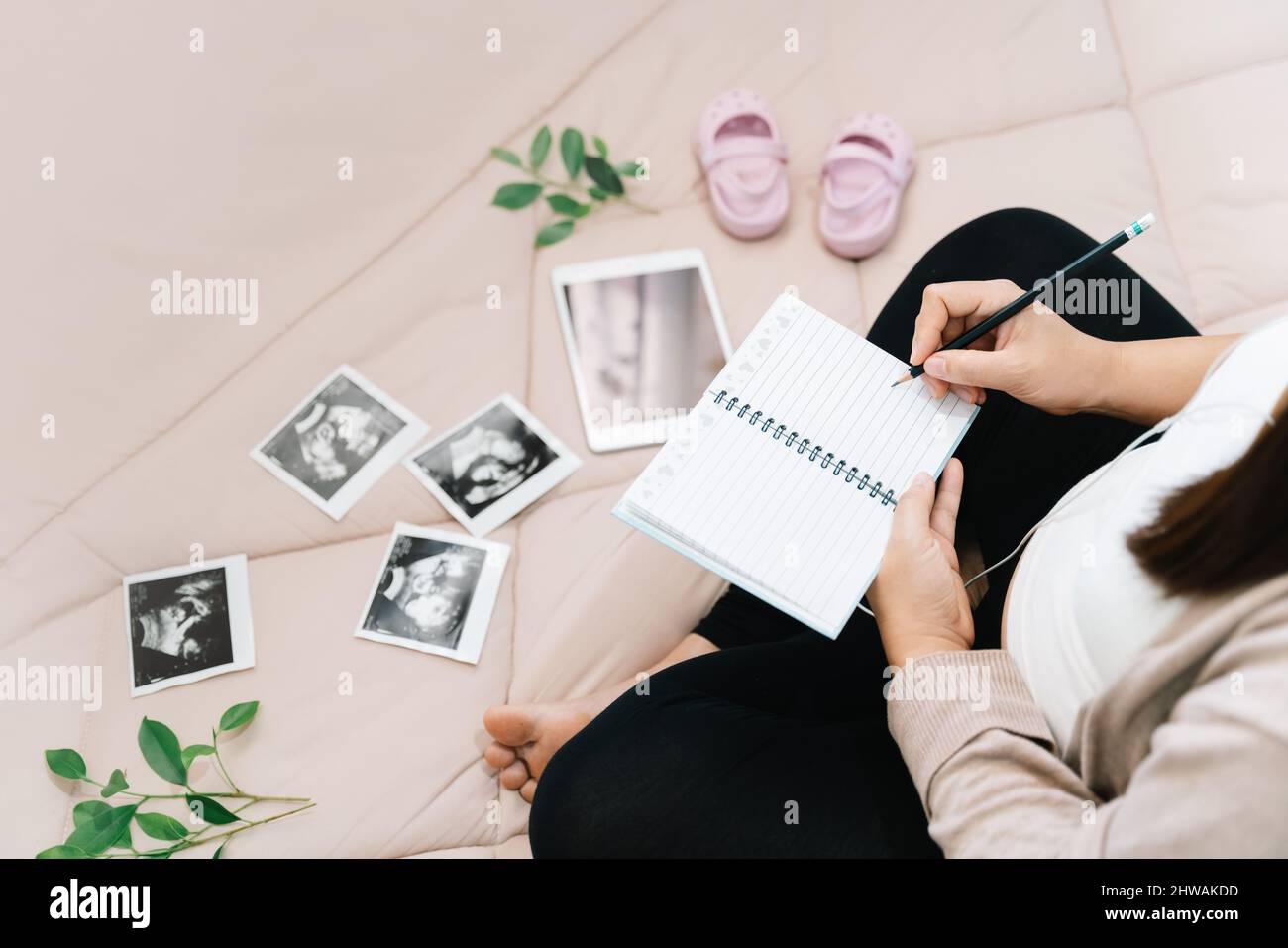A Pregnancy dairy.Top view of pregnant woman writing thoughts down in ...