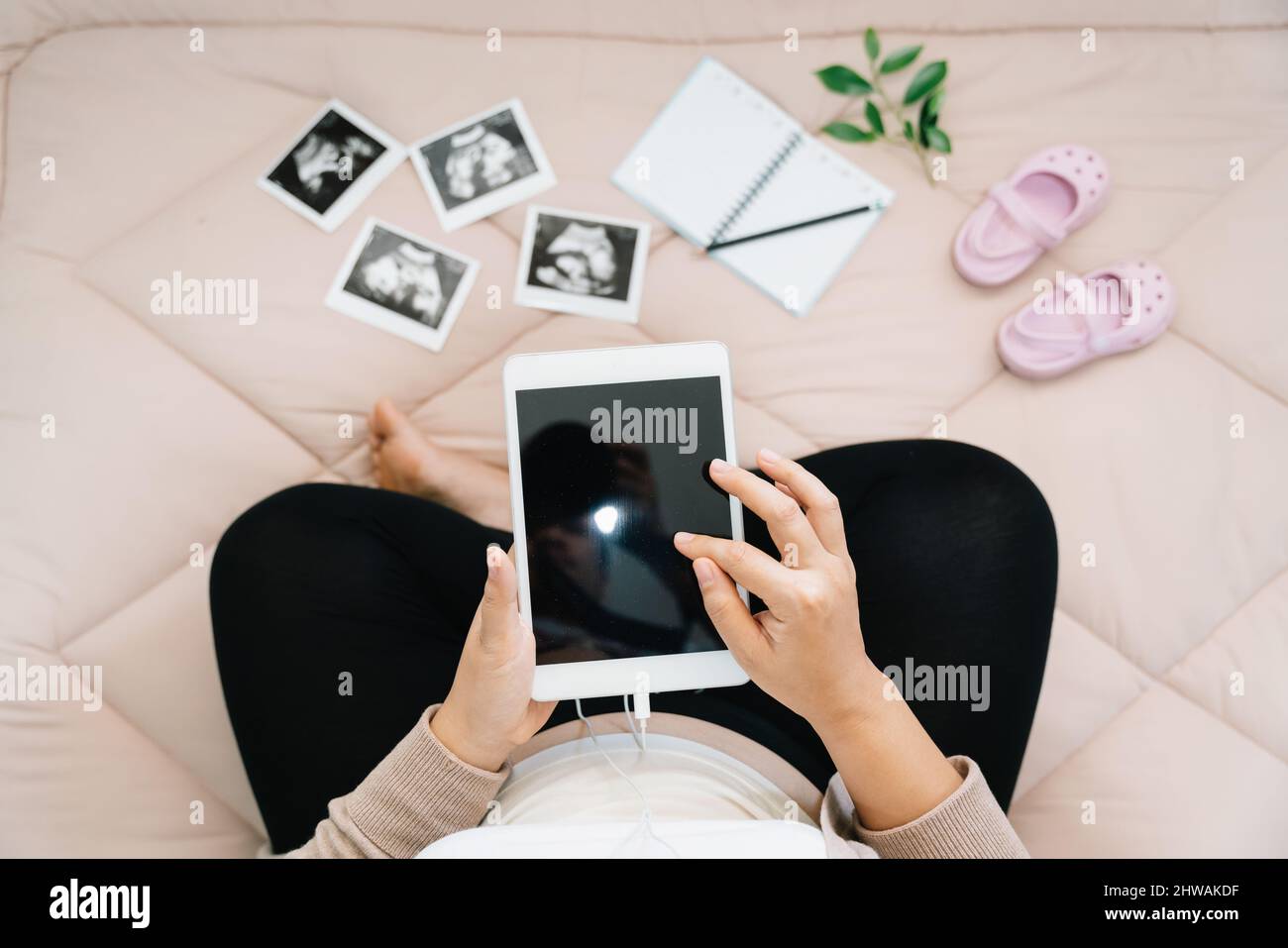 A Pregnancy dairy. Top view of pregnant woman writing thoughts down ...
