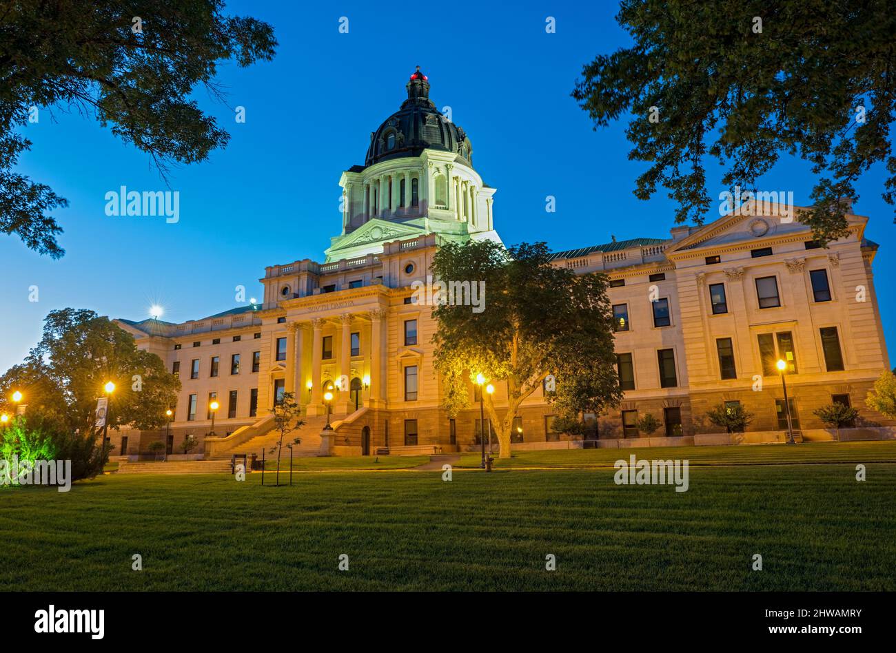 The State Capitol is illuminated at dusk in Pierre, South Dakota, USA ...