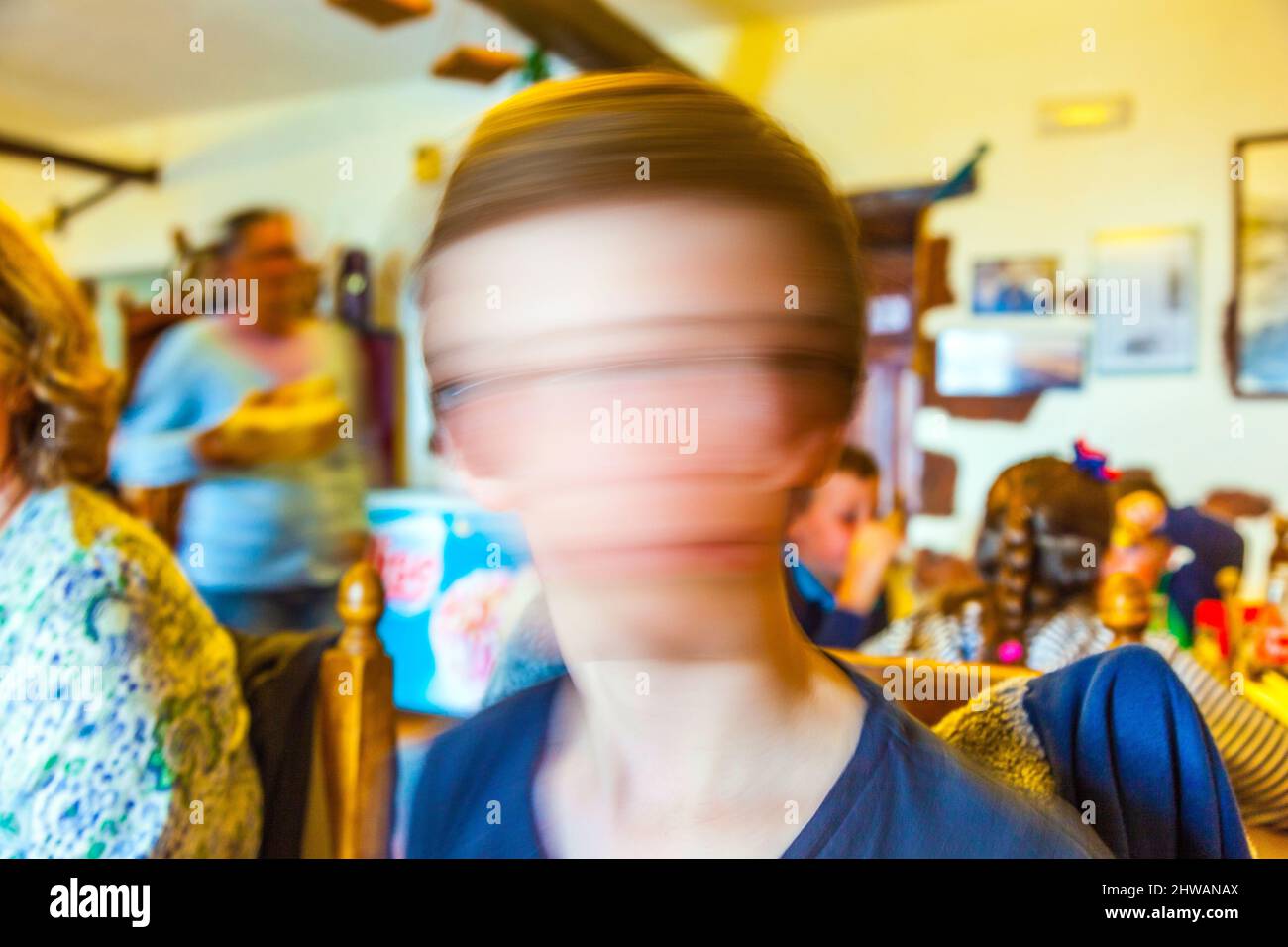 cute young boy in a restaurant shaking his head Stock Photo - Alamy